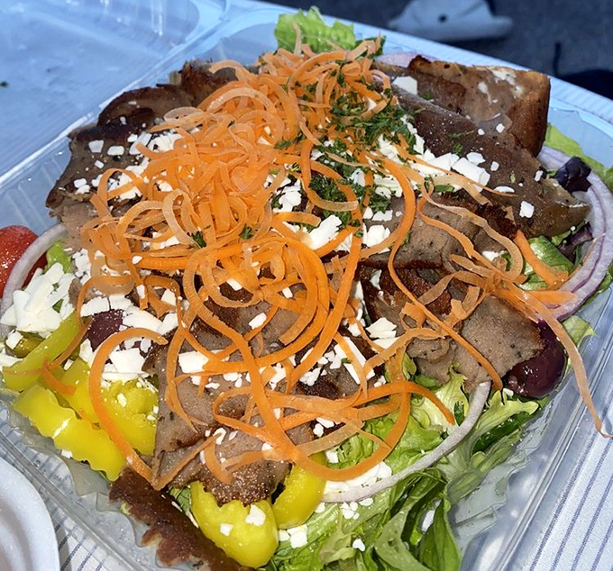 This isn't just a salad—it's an architectural achievement. Layers of greens, peppers, and gyro meat topped with a spiral of carrots that would make Frank Lloyd Wright jealous.