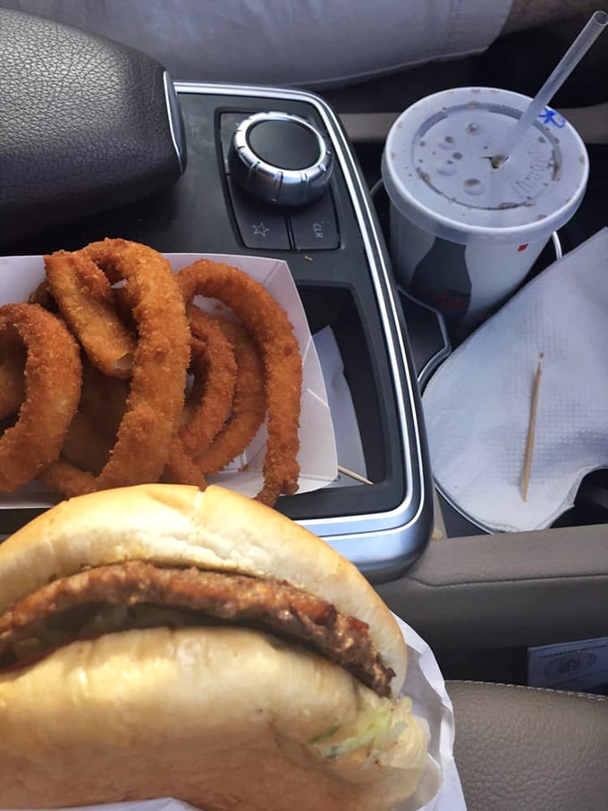 Car dining at its finest: a juicy burger and golden onion rings that transform your vehicle into the best seat in the house.