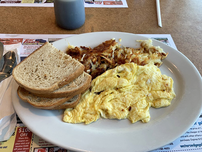 A plate that screams "good morning" louder than your alarm clock&mdash;fluffy scrambled eggs and home fries that actually taste like potatoes.
