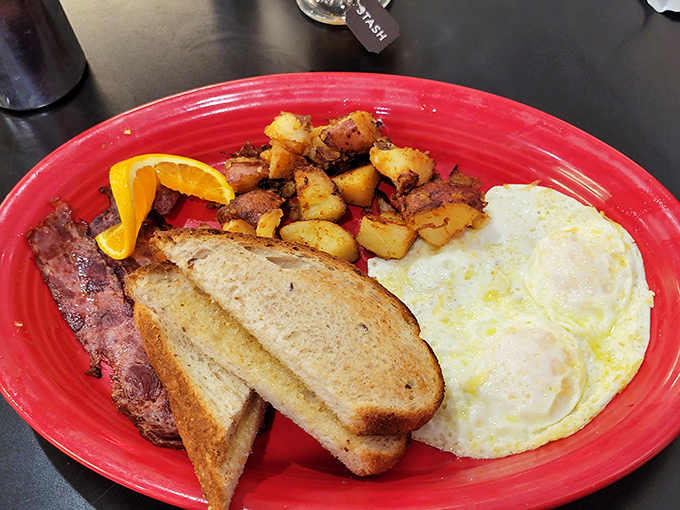 The breakfast trinity: perfectly cooked eggs, crispy home fries, and toast ready for butter application. Simple pleasures executed with respect and care.
