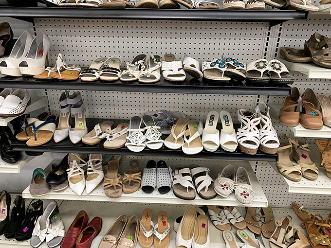 Women's shoes line these shelves like a rainbow of second chances, each pair waiting for its next dance.