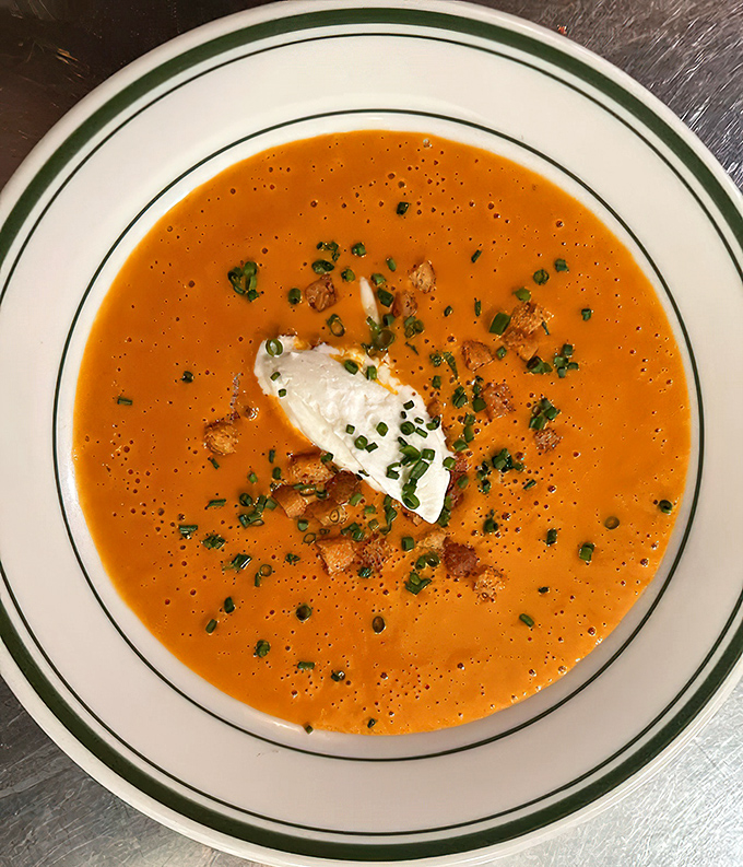 Manhattan clam chowder topped with a dollop of cream and fresh herbs—like a tomato-based sonnet to the sea.