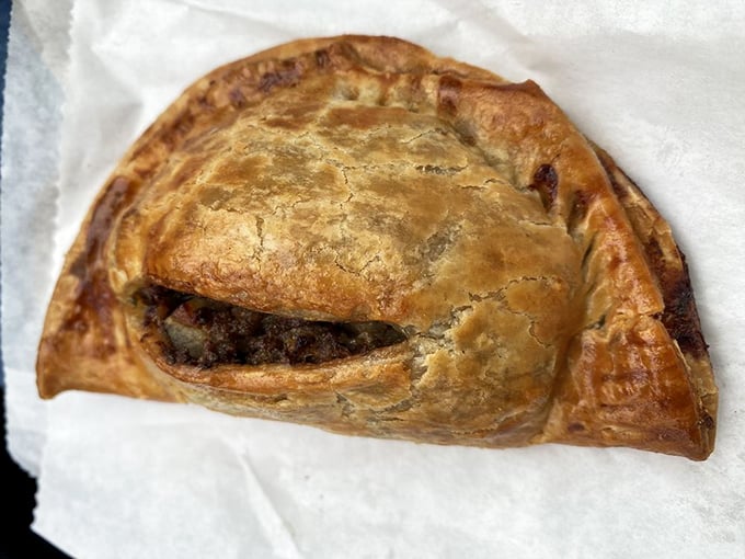 The meat pie's golden, flaky exterior is nature's perfect to-go container for savory fillings. Portable perfection for Oregon adventures.