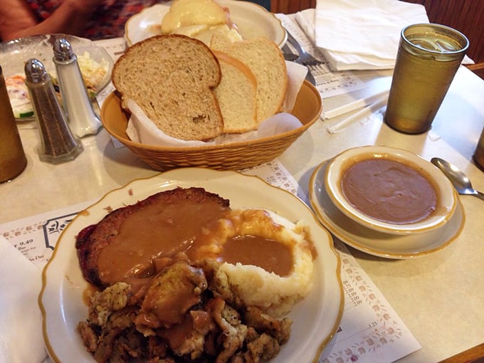 The holy trinity of comfort: fresh-baked bread, hearty meatloaf, and mashed potatoes swimming in gravy. Diet culture doesn't stand a chance here.