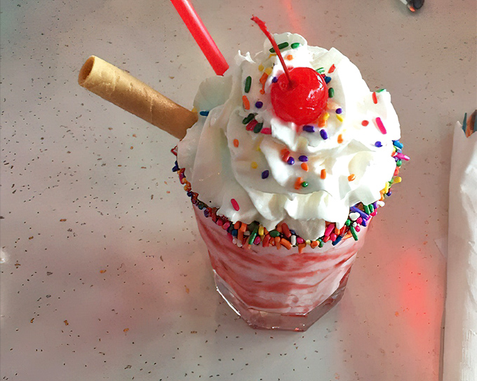 This isn't just a milkshake&mdash;it's dessert architecture. The whipped cream skyscraper topped with sprinkles and a cherry says "diet starts tomorrow."