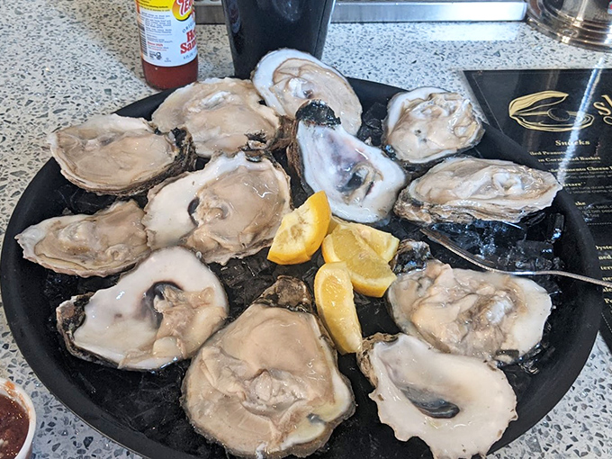 Nature's perfect appetizer: briny, plump oysters on the half shell with lemon wedges. The ocean's version of "I'll have what she's having."