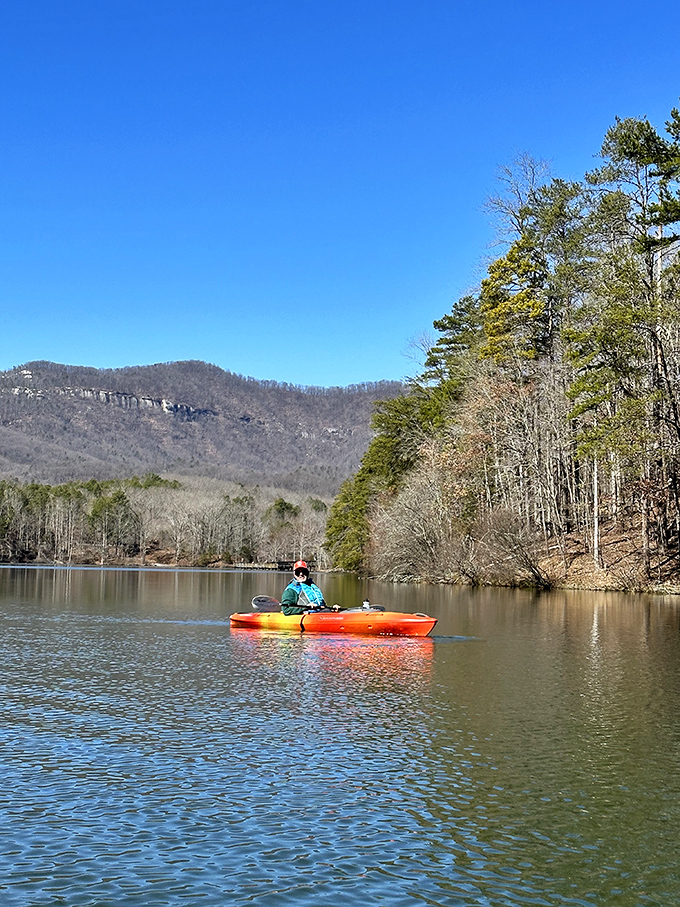 That vibrant kayak isn't just transportation &ndash; it's a floating front-row seat to South Carolina's most spectacular mountain theater.