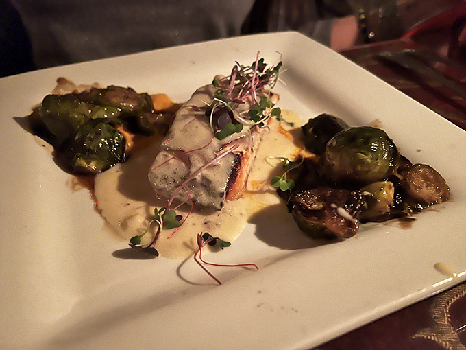 Fine dining meets cave dwelling in this artfully plated fish dish. The Brussels sprouts look like they've found their life's purpose.