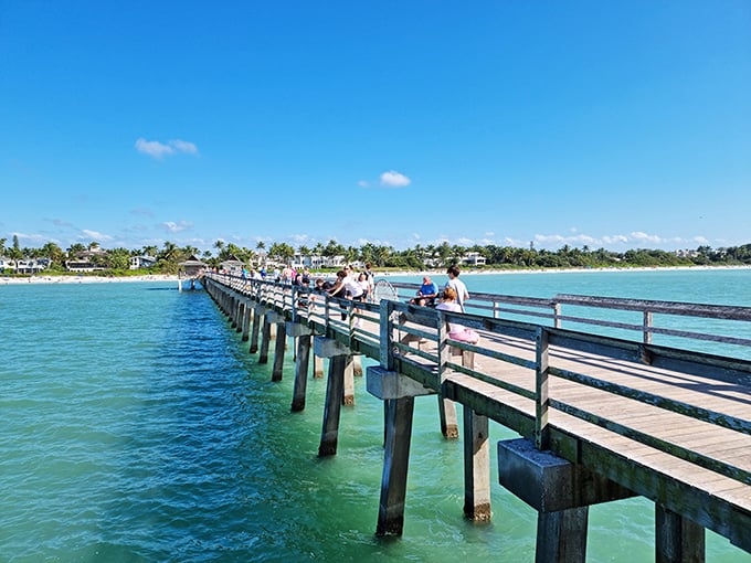 Naples Pier stretches into the Gulf like nature's runway, offering front-row seats to sunsets that make even teenagers look up from their phones.