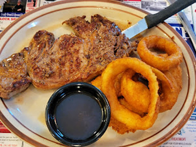 This isn't just a steak&mdash;it's a commitment. Golden onion rings and a side of dipping sauce complete this plate of pure satisfaction.