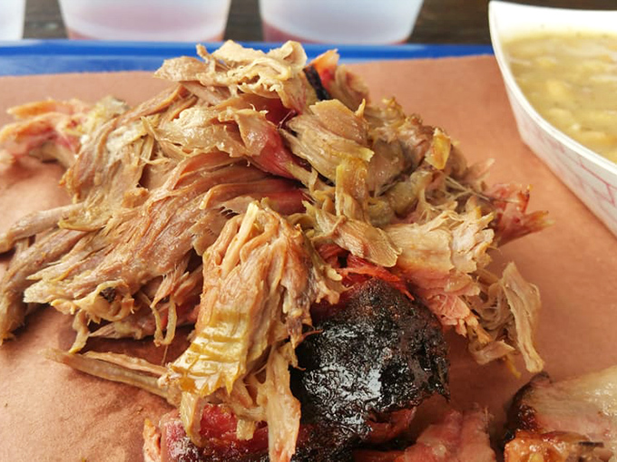 Pulled pork so tender it surrenders completely, with edges kissed by smoke and fire. This is what patience tastes like.