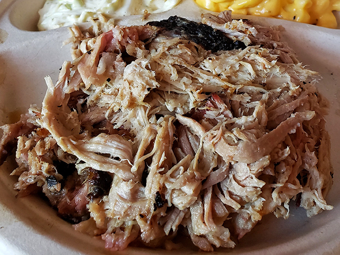 Pulled pork that surrenders completely to the fork. This isn't just meat; it's a textural masterpiece of bark and tender strands.