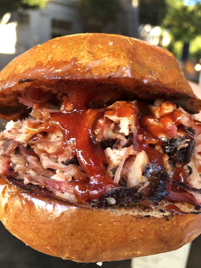 The pulled pork sandwich isn't messing around&mdash;tender strands of smoky pork nestled in a brioche bun, ready for their close-up. 