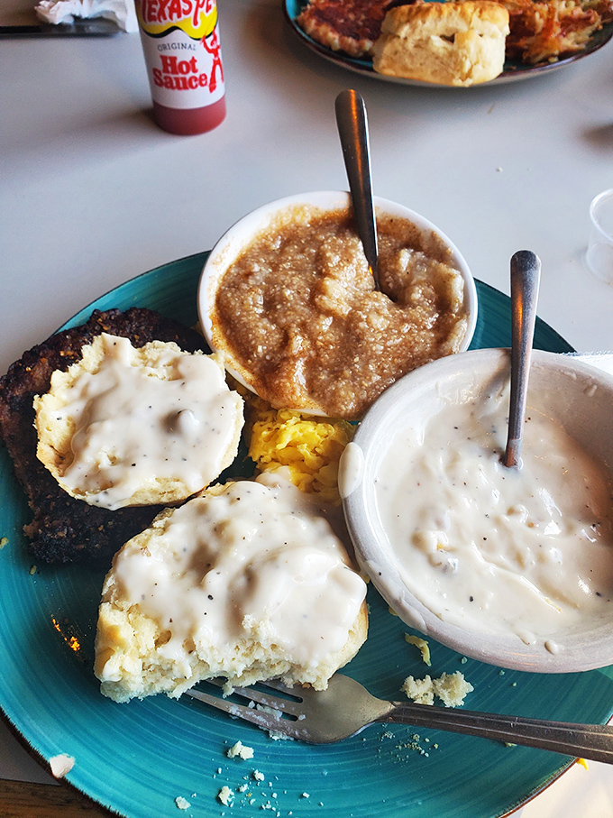 Biscuits swimming in creamy sausage gravy &ndash; the kind of breakfast that makes you want to write poetry about carbohydrates.