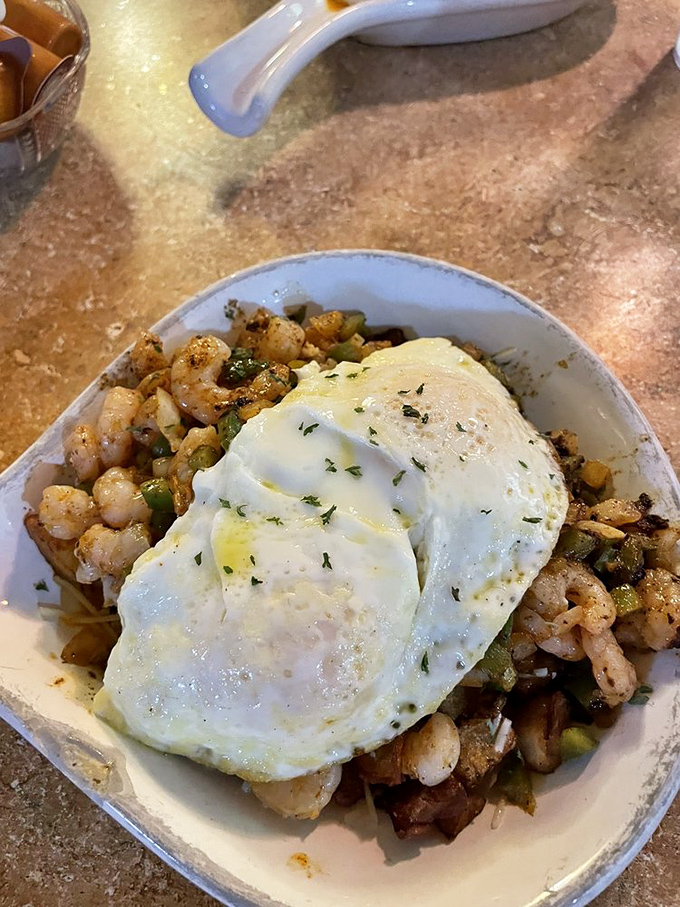 The seafood skillet—where Gulf shrimp meets perfectly cooked eggs in a morning romance that would make Neptune himself order seconds.