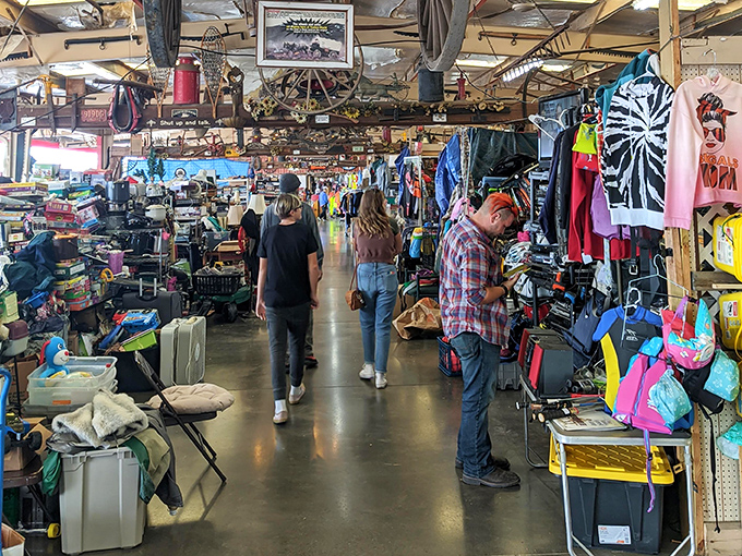 The true Traders World experience: shoppers navigating aisles flanked by merchandise that defies categorization, like explorers in a retail jungle.