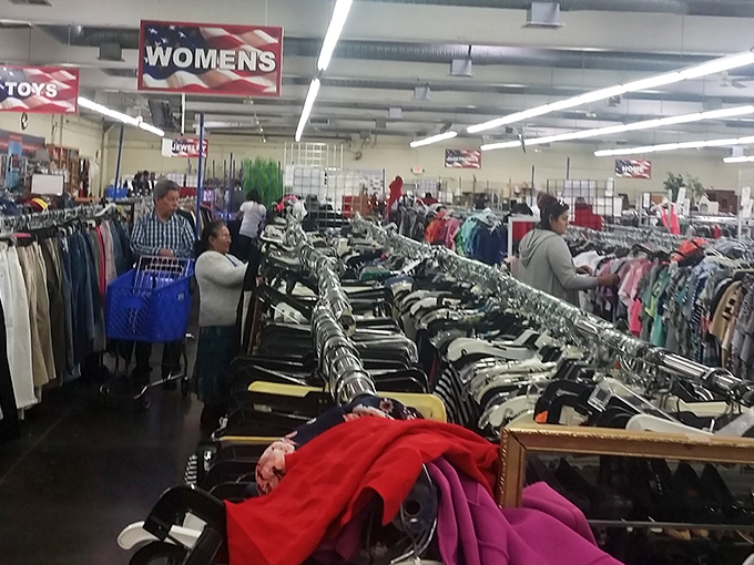 The women's section: where shoppers become archaeologists, carefully sifting through layers of fabric history to unearth that perfect hidden gem.