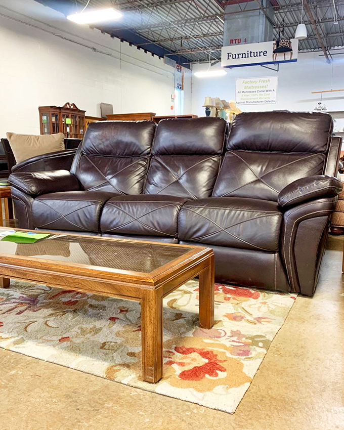 This leather sofa has seen less sitting than most showroom models and costs a fraction of what you'd pay for its brand-new twin.