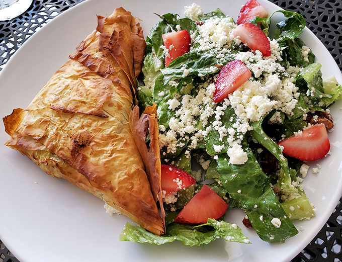 Flaky phyllo triangles hide a spinach-feta treasure, while the strawberry-studded salad brings brightness that could outshine a Carolina summer day.