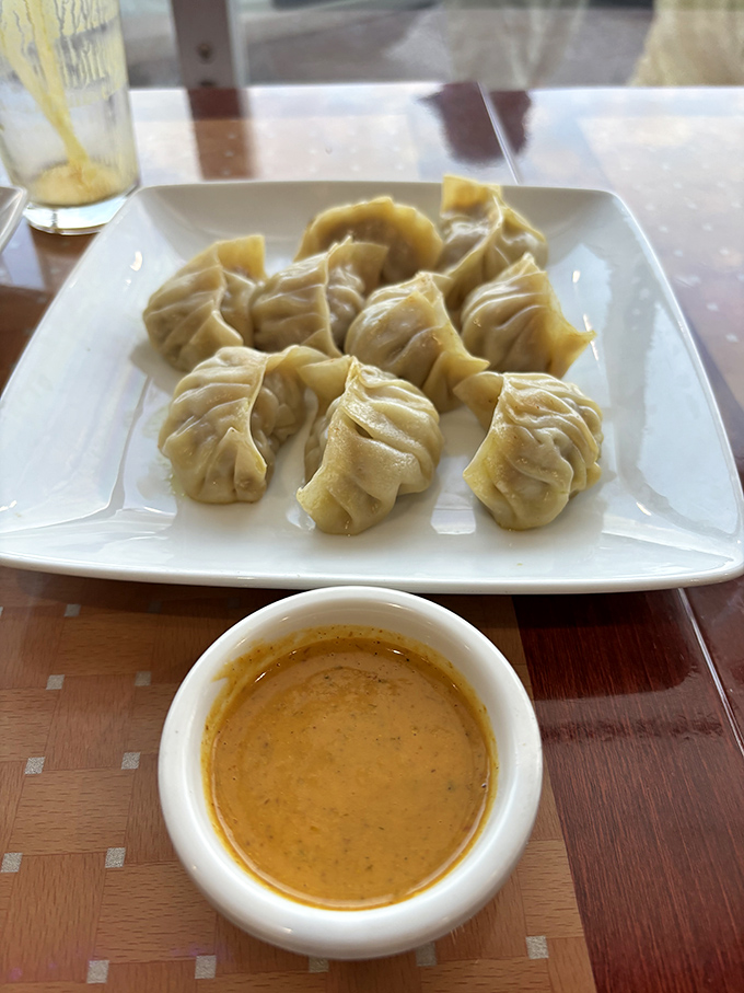 Nepali momos are like little dumplings of joy, their delicate folds hiding savory fillings that pair perfectly with that golden dipping sauce.