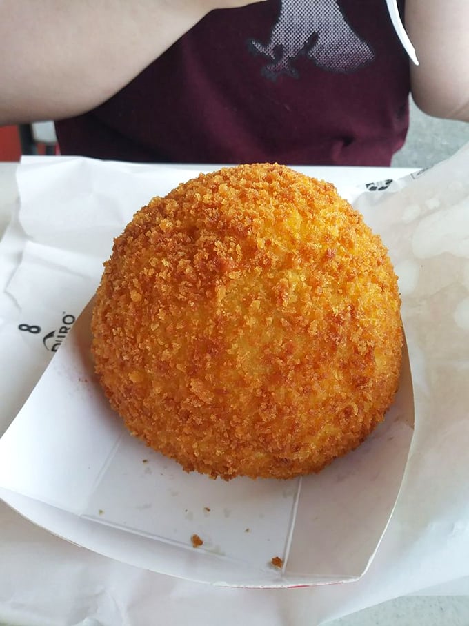 A perfectly formed deviled crab awaits its destiny. Like a savory baseball of happiness, this Tampa specialty promises spice, texture, and tradition in every bite.