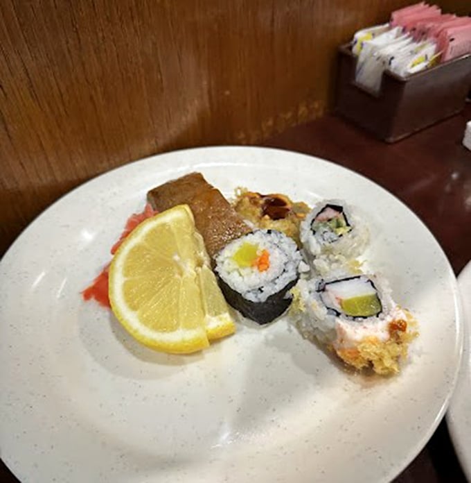 Sushi that defies the buffet stereotype, with fresh pieces artfully arranged alongside a bright lemon wedge. A little ocean oasis on your plate.