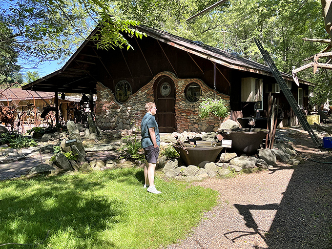 The stone Hobbit House stands as a charming counterpoint to the metal monsters, offering visitors a glimpse into the creative process.