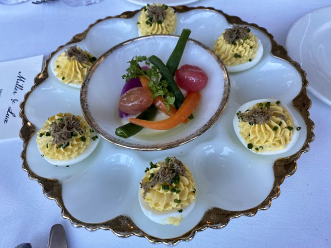 Deviled eggs elevated to art form. These little yellow mountains topped with truffle make ordinary eggs feel like they need to step up their game.