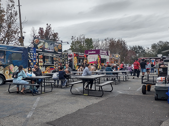 The outdoor food truck court offers a United Nations of flavors, where picnic tables become neutral territory for international culinary diplomacy.