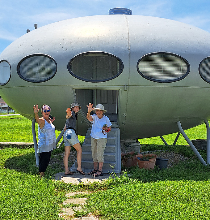 "We come in peace!" Enthusiastic visitors pose on the steps of the Futuro House, making first contact with this rare piece of architectural history.
