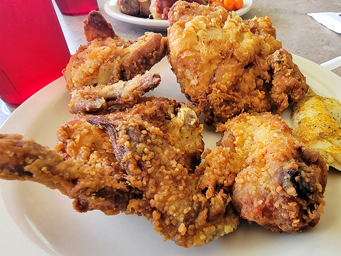 Fried chicken that makes you question why anyone bothers with fancy food. The crunch echoes across the room, announcing its arrival before you take a bite.
