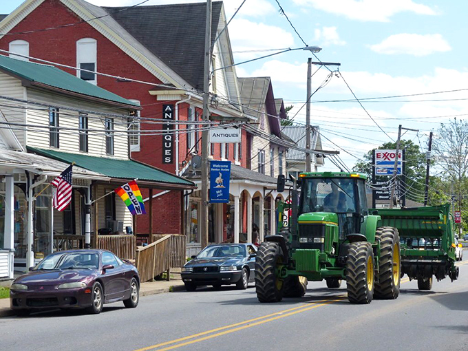A tractor rolling past antique shops&mdash;Benton perfectly blends farm life with small-town charm and friendly storefronts on a sunny afternoon.