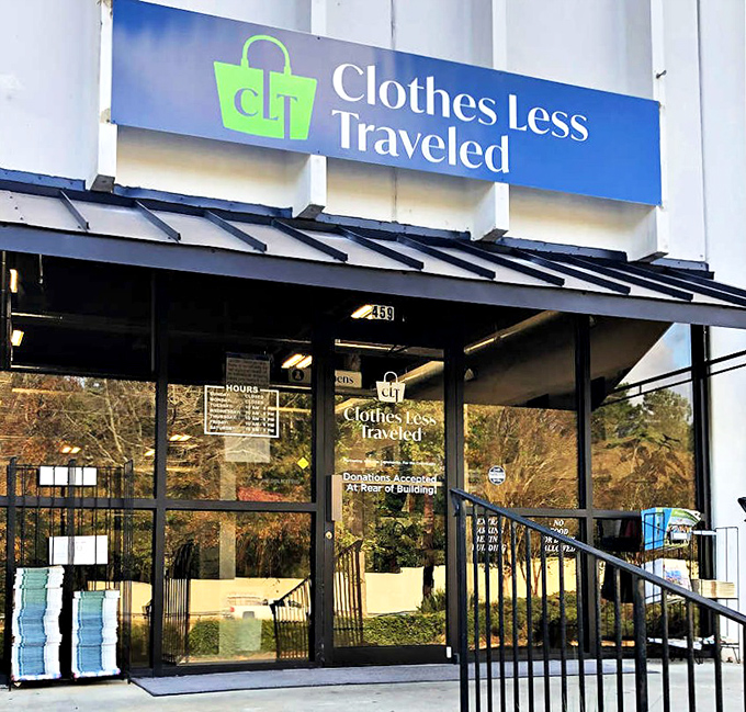 Clothes Less Traveled's sleek blue signage promises a boutique thrifting experience that delivers on style without the sticker shock.
