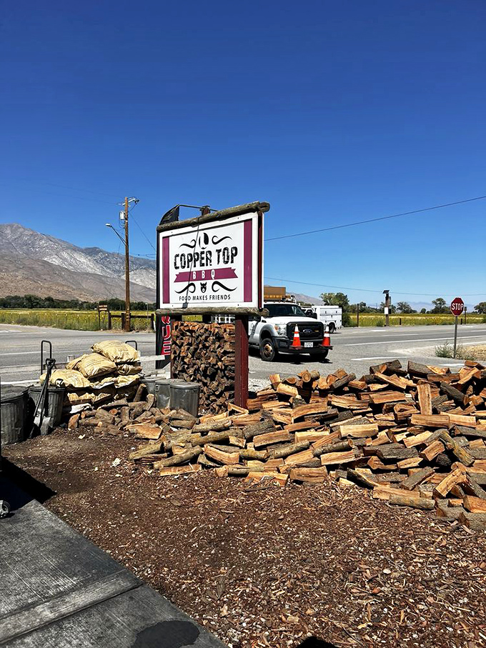 Copper Top BBQ's sign stands tall against the Eastern Sierra backdrop. Mountain air makes everything taste better, especially smoked meat. 