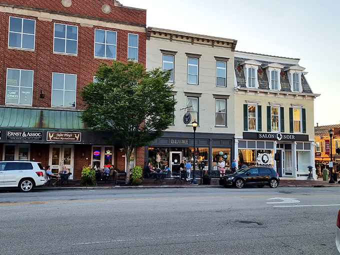 This charming small-town street feels like a blend of classic Americana with its brick facades and cozy shops. The inviting storefronts make you want to stop and stay awhile.