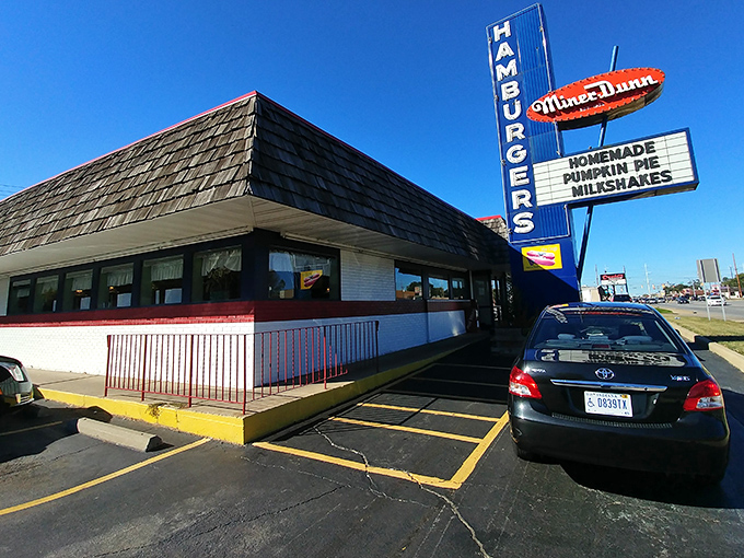 That vintage sign stands tall like a mid-century monument to America's love affair with perfect burgers.