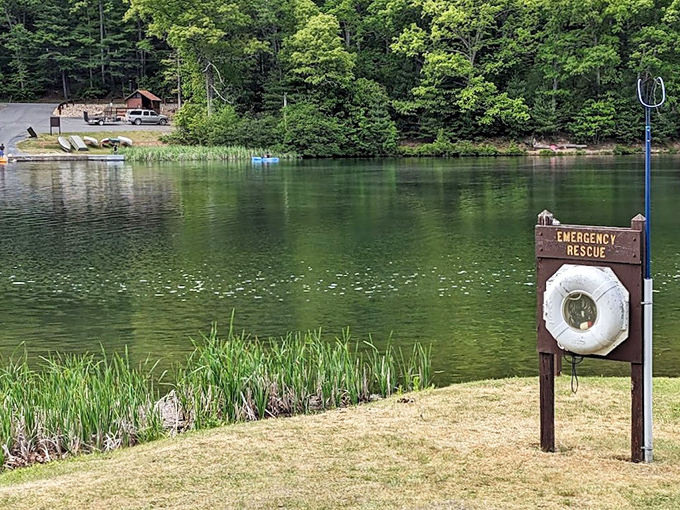 Emerald waters meet forest green at Poe Valley, where a lifeguard stand stands ready for swimmers seeking mountain-fresh coolness.