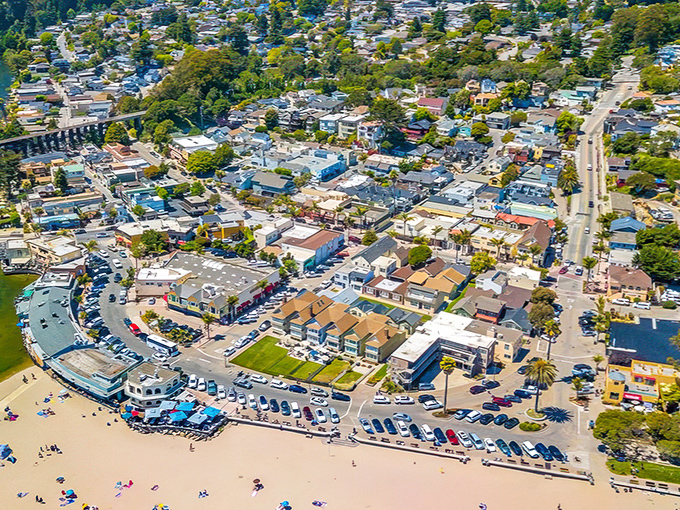The beach boardwalk stretches endlessly, promising cotton candy memories and ocean adventures ahead.