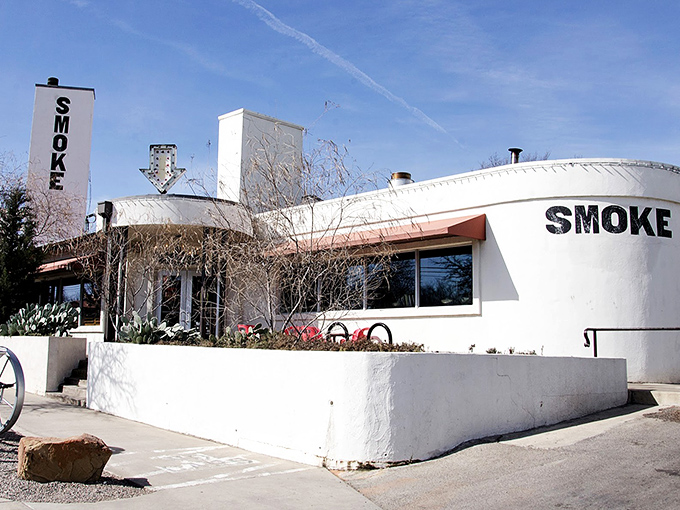 Smoke BBQ's stark white building stands like a blank canvas, ready to paint your palate with smoky hot dog masterpieces.