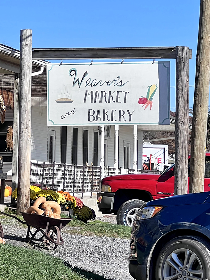 Weaver's Market sign hangs like a promise of rural authenticity. That wheelbarrow of gourds is just the opening act!