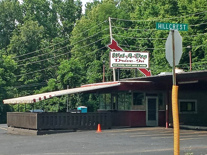 Wot-A-Dog's distinctive red arrow sign points to happiness, served between a bun with your choice of toppings.