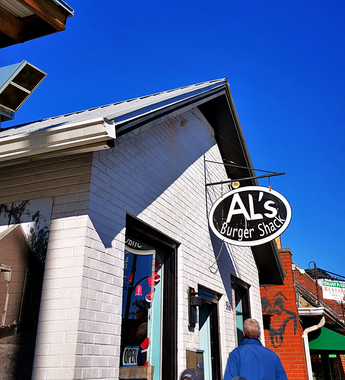 Al's Burger Shack sign hangs proudly against a perfect blue sky, beckoning burger lovers to this Franklin Street institution.