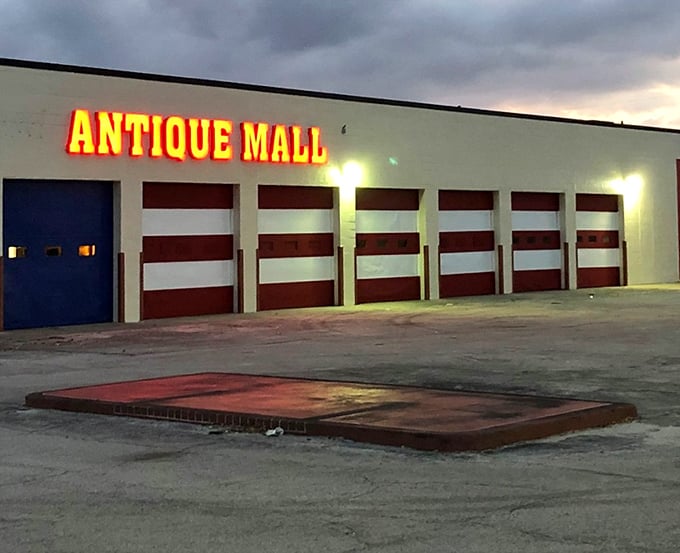 As twilight falls, the illuminated sign glows like a beacon for night-owl collectors seeking one more vintage treasure before bedtime.