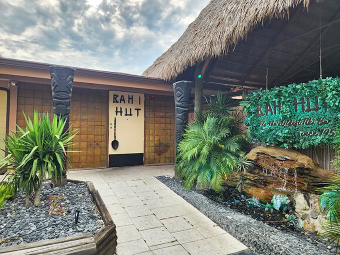 The gentle waterfall outside Bahi Hut whispers promises of tropical escapes and legendary cocktails that pack a delicious punch.