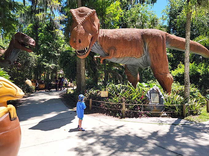 When dinosaurs ruled Florida! This fearsome T-Rex stands guard among palm trees, ready for your family's prehistoric photo op.