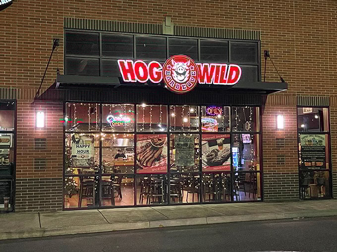 Night falls on Hog Wild BBQ, where the glowing windows beckon like a lighthouse for the barbecue-starved soul.