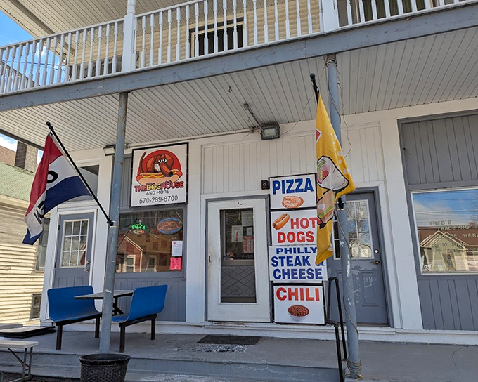 The charming porch of The Dog House invites you to sit a spell – after you've ordered one of their famous franks, of course.