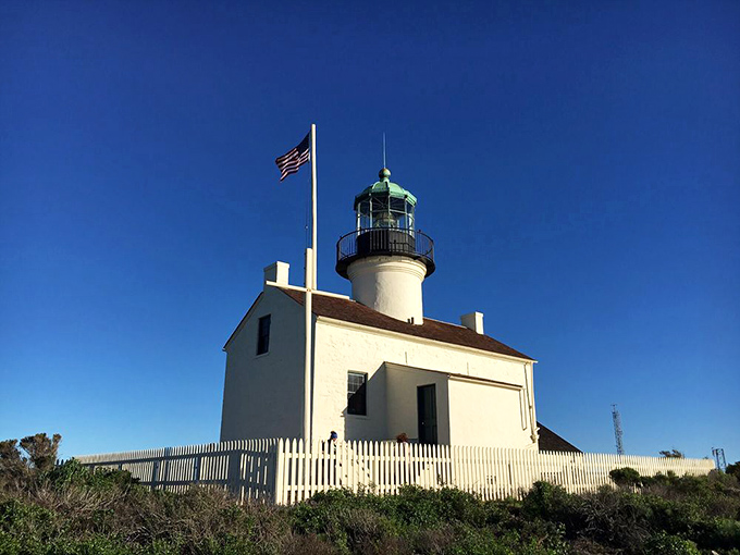 The Old Point Loma Lighthouse stands guard like a time capsule from 1855, when San Diego was just a twinkle in California's eye.