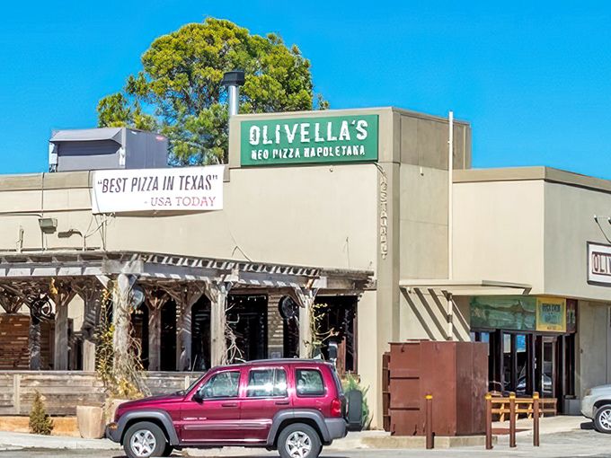 Olivella's Pizza and Wine: That "Best Pizza in Texas" banner isn't just bragging&mdash;it's a promise. The weathered wood exterior hints at old-world traditions inside! 