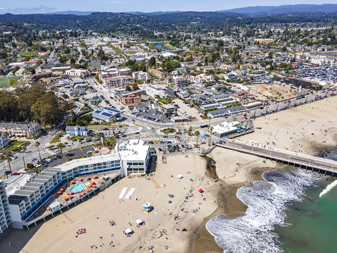 Coastal hills embrace sandy shores in this perfect blend of mountains meeting sea.